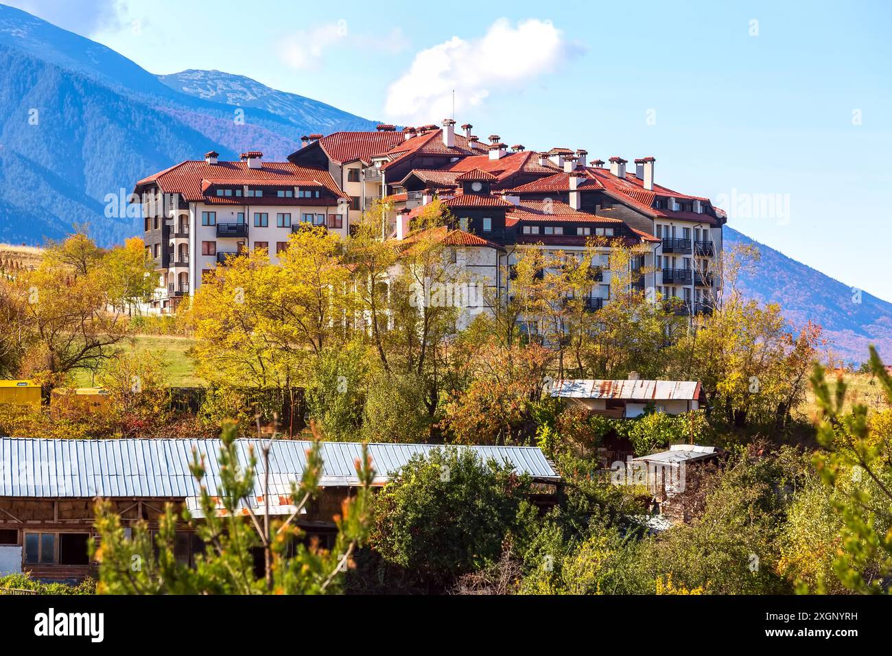 Bansko, Bulgaria town view with houses and colorful yellow autumn trees ...