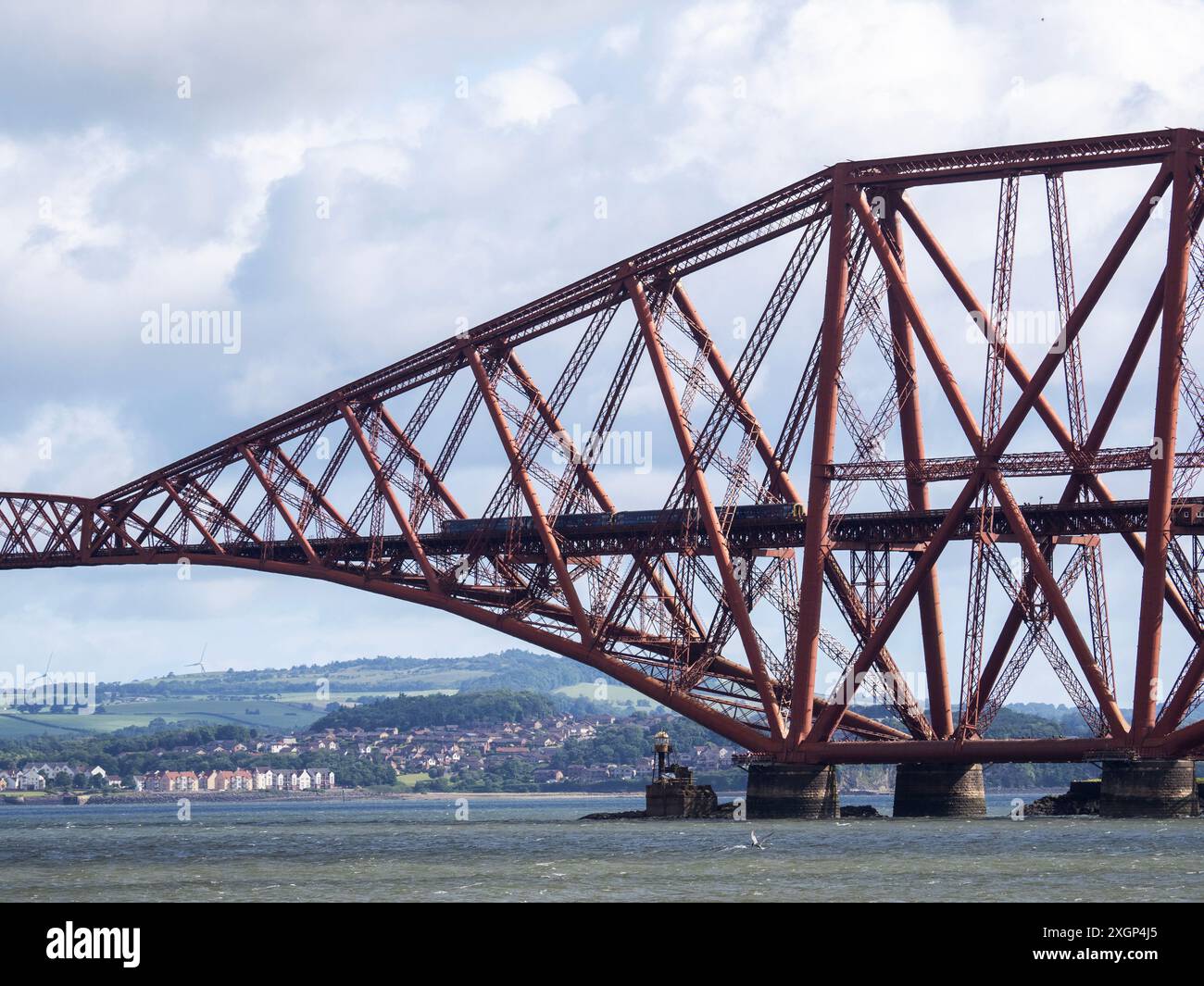 A train crossing the Forth Bridge carrying the railway in Queensferry ...