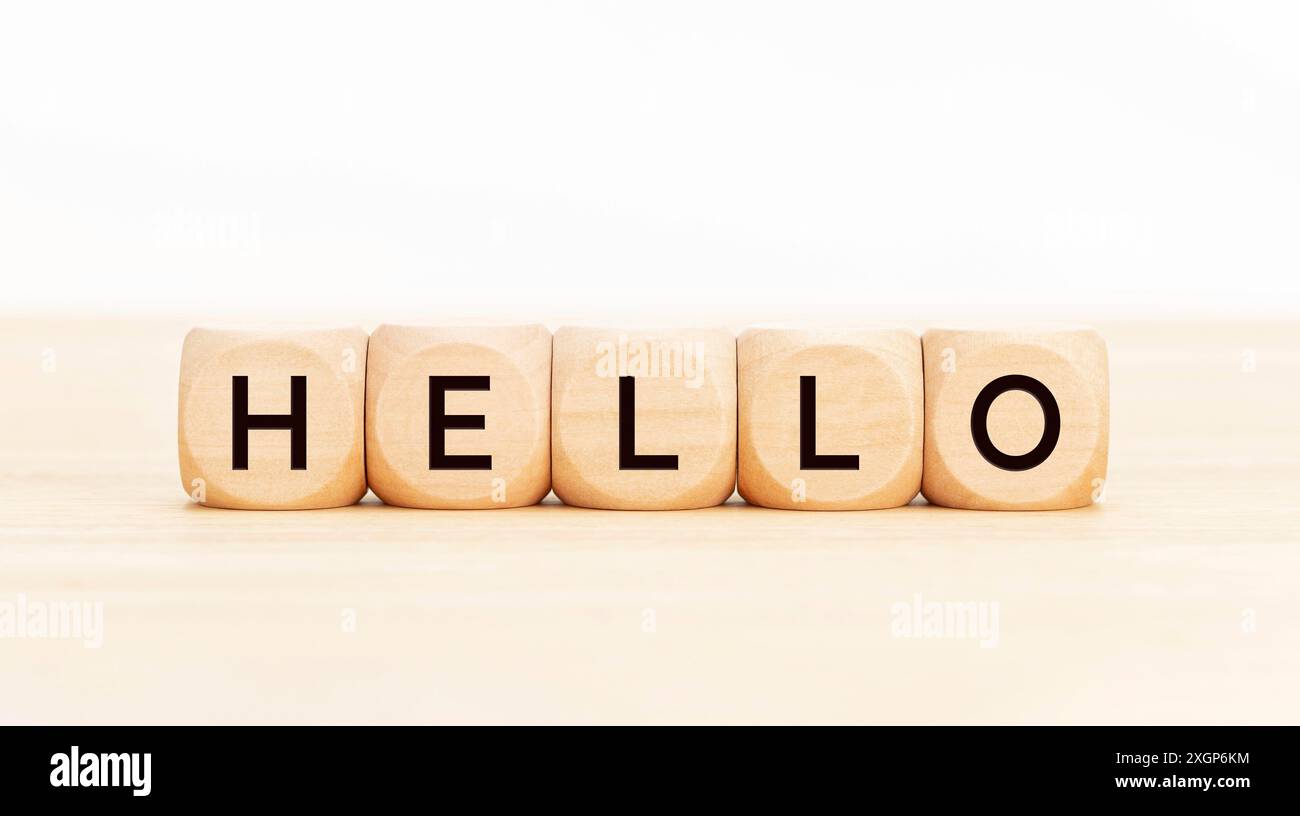 Hello word in wooden blocks on table. White background. Copy space ...