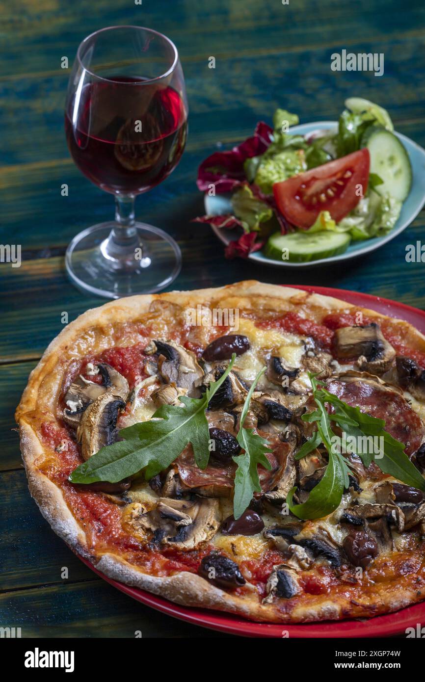 Overview of a pizza with salad Stock Photo - Alamy