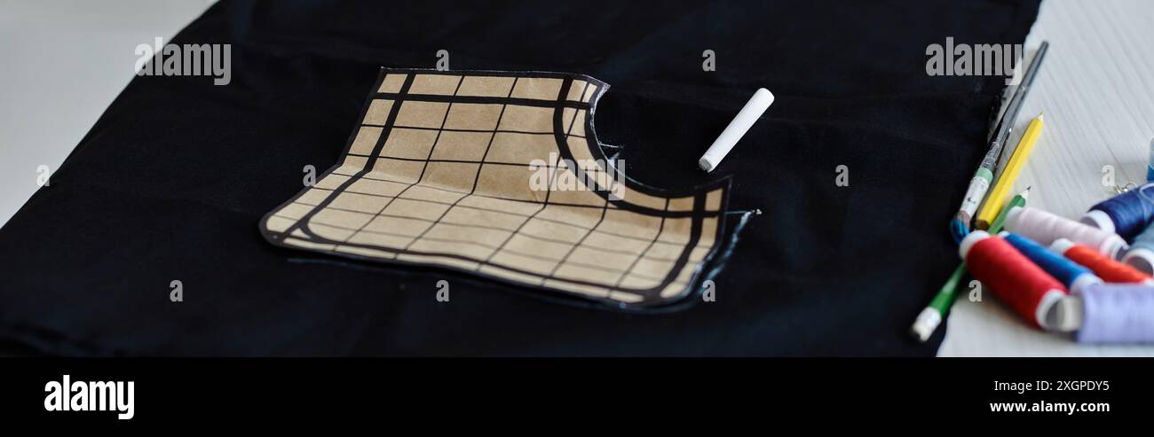 A close-up shot of a fabric grid pattern and chalk, tools which ...