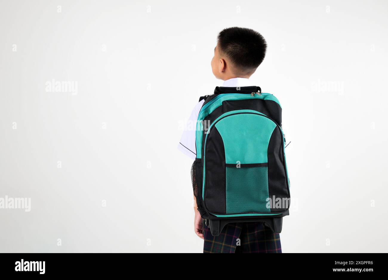 Back view Asian little boy primary posing with black and green backpack ...