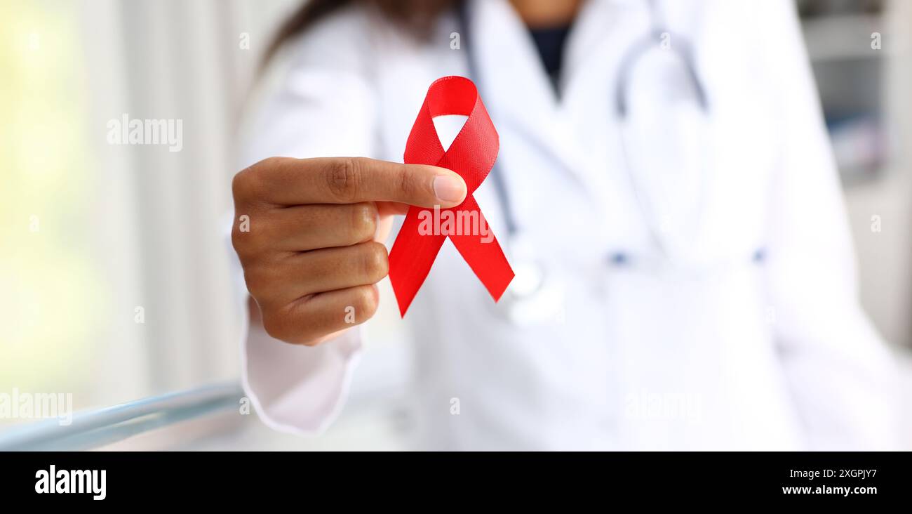 Female doctor holding red ribbon hi-res stock photography and images ...