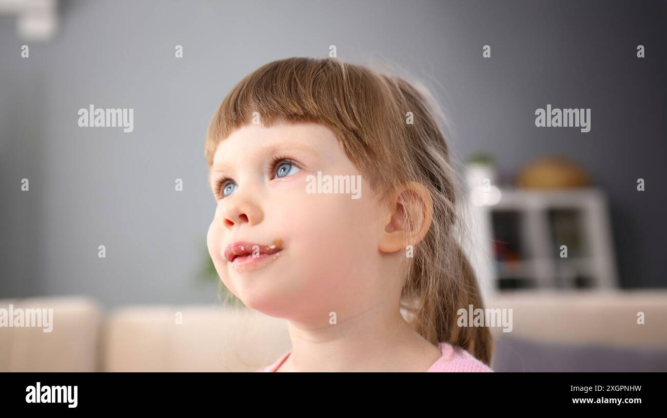 Little girl eating sweet chocolate candy with trace at her mouth Stock ...