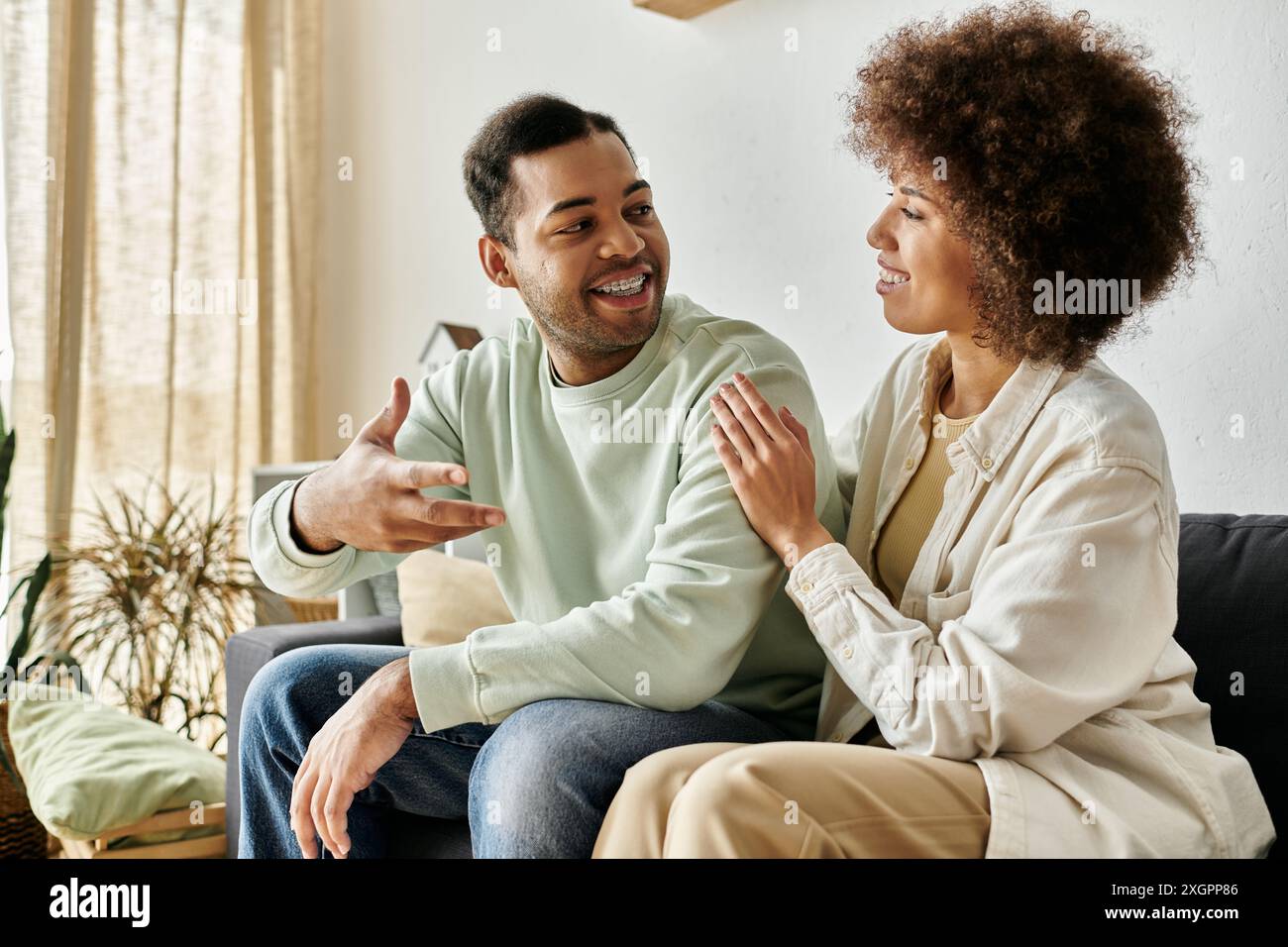 Couple relaxing on sign hi-res stock photography and images - Alamy