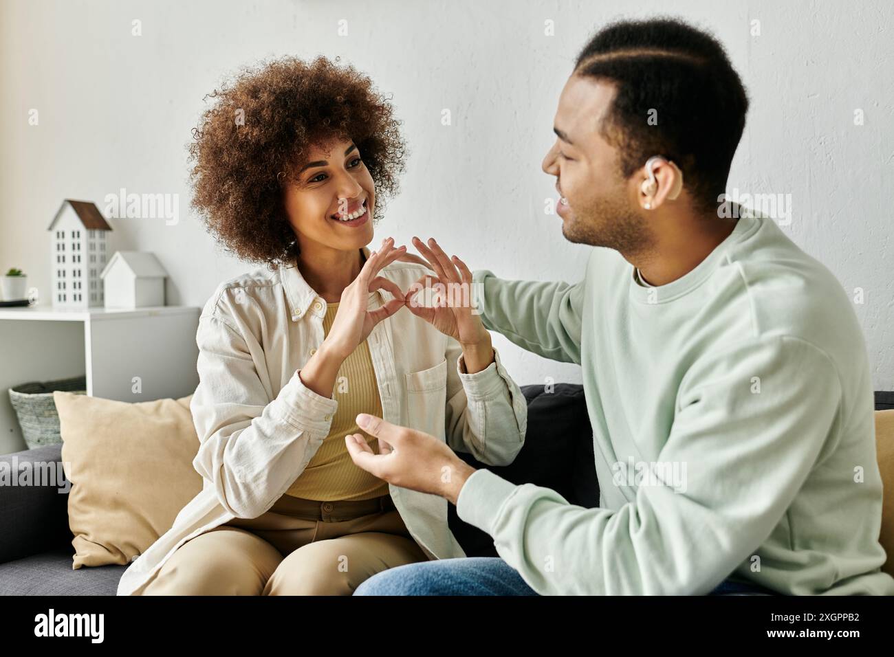 An African American couple communicates using sign language while ...