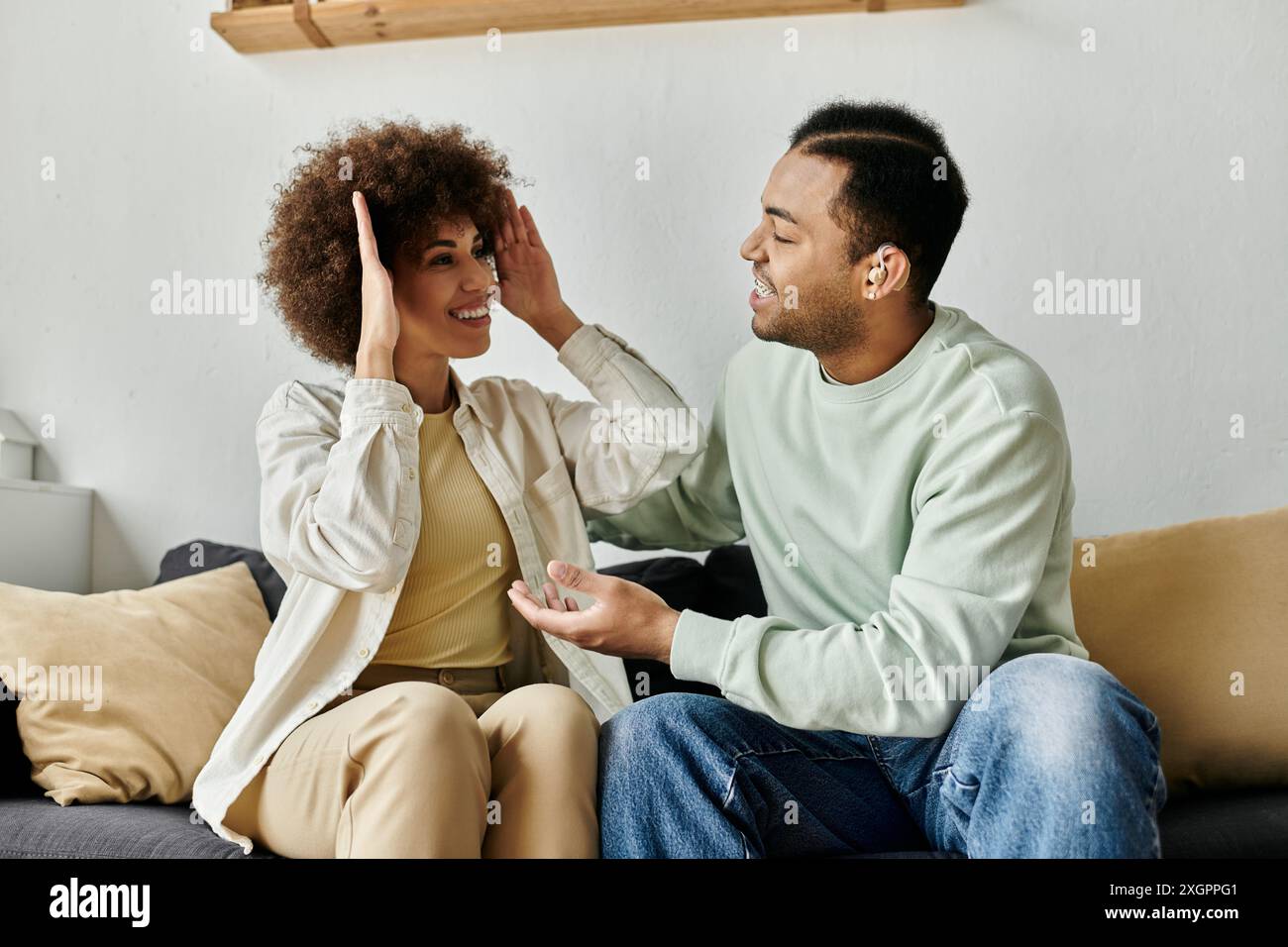 An African American couple uses sign language to communicate while ...
