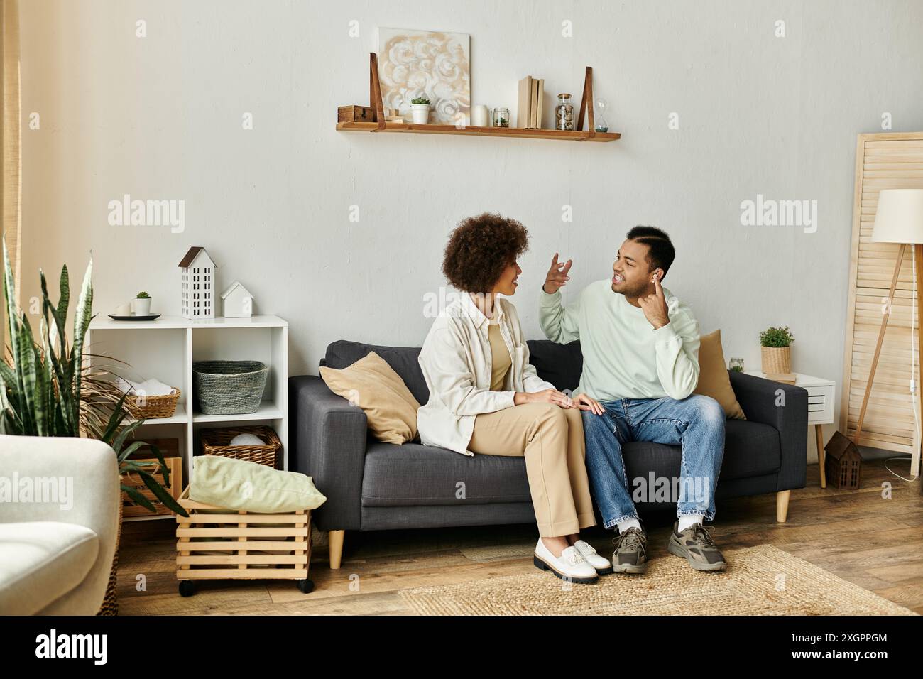 An African American couple uses sign language to communicate while ...