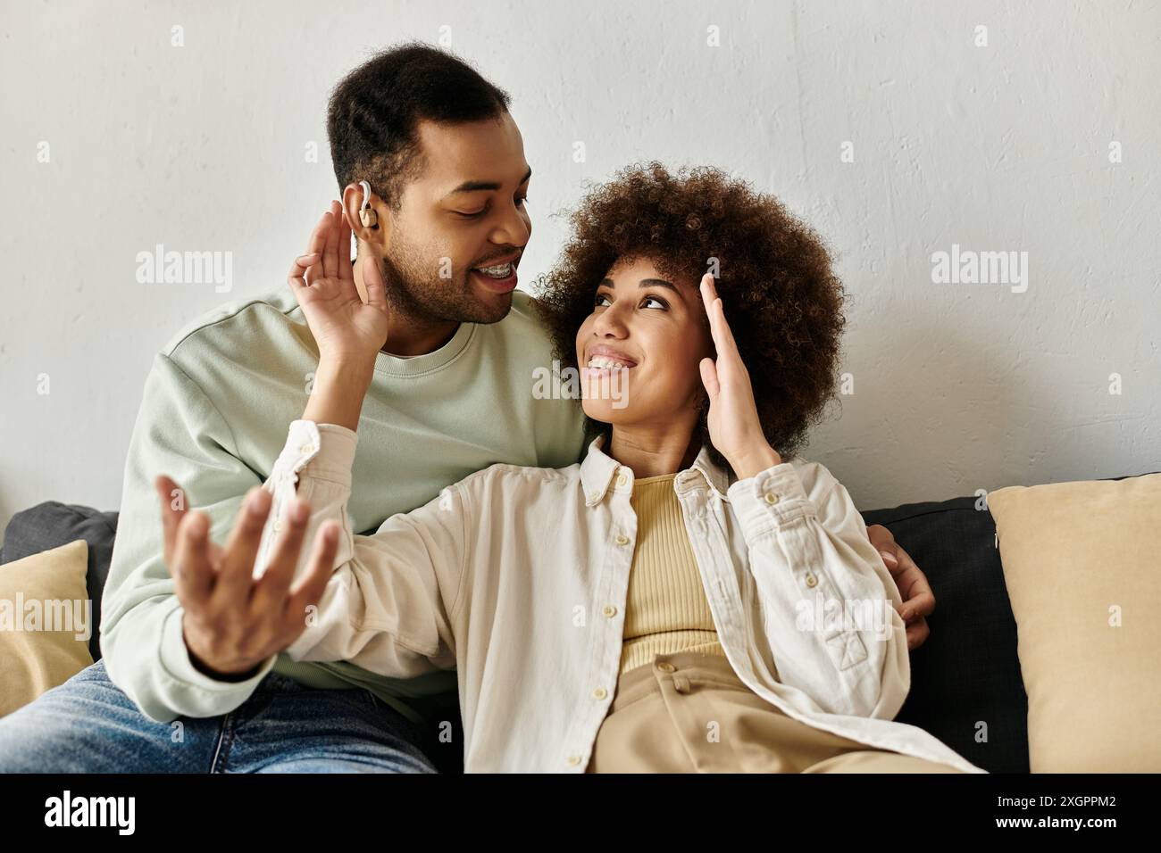 An African American couple uses sign language to communicate while ...