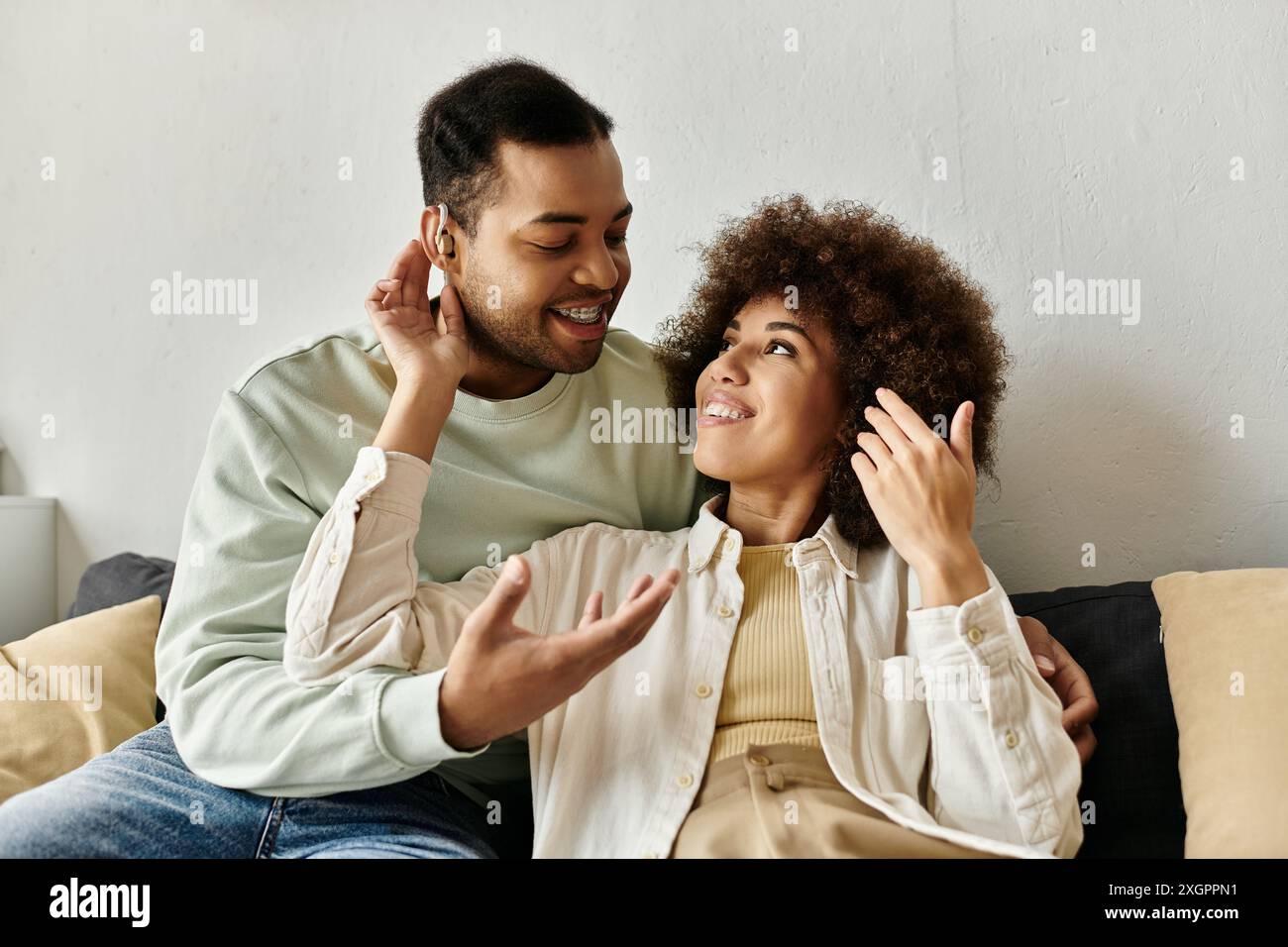 An African American couple uses sign language to communicate while ...