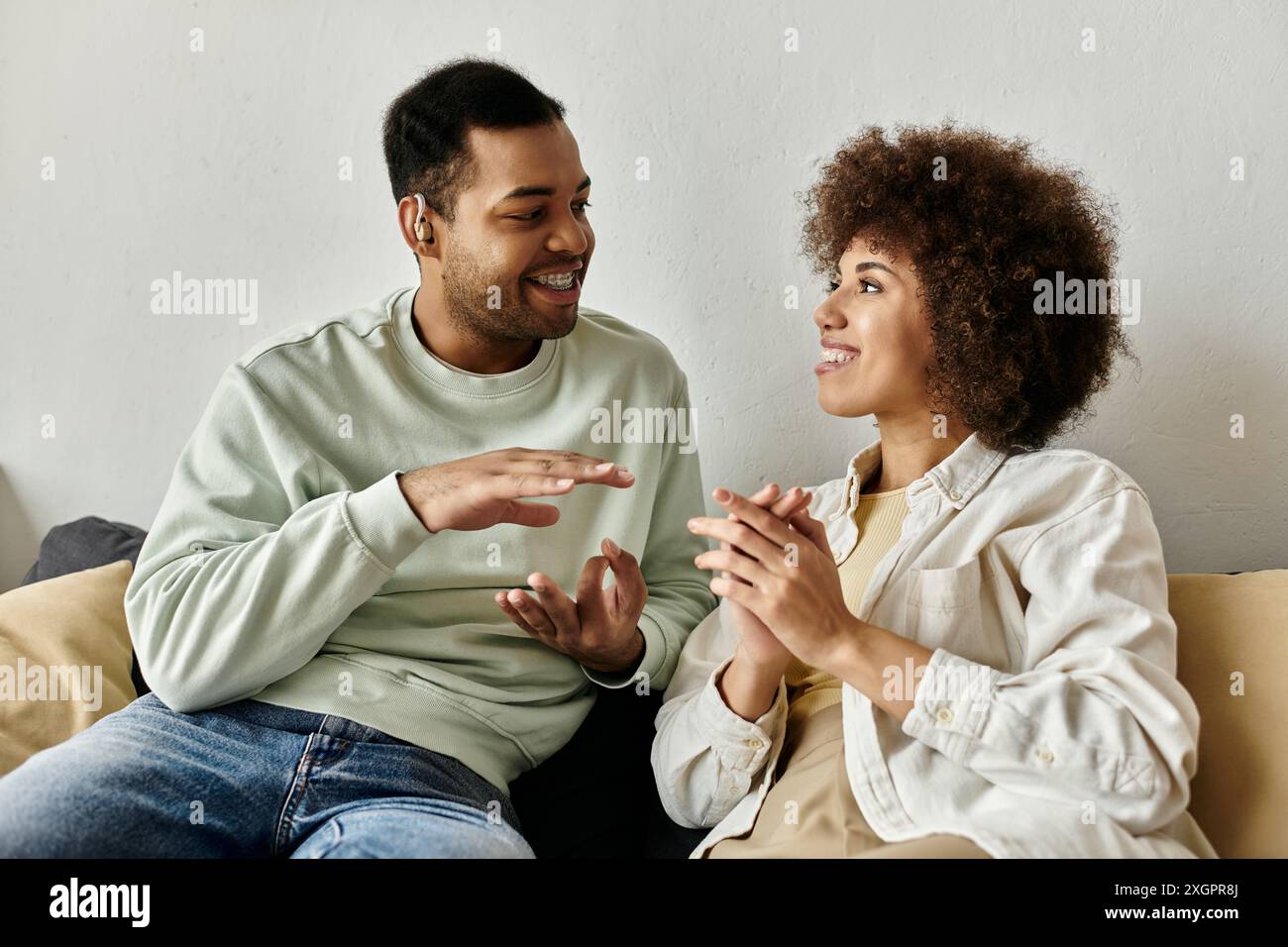 An African American couple communicates through sign language while ...