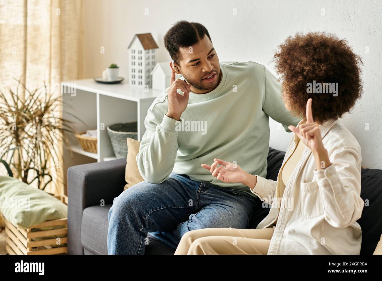 An attractive African American couple uses sign language to communicate ...