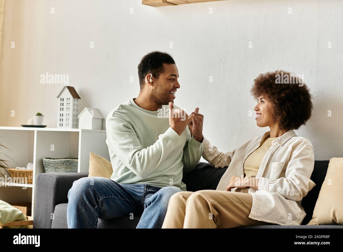 An African American couple communicates using sign language while ...