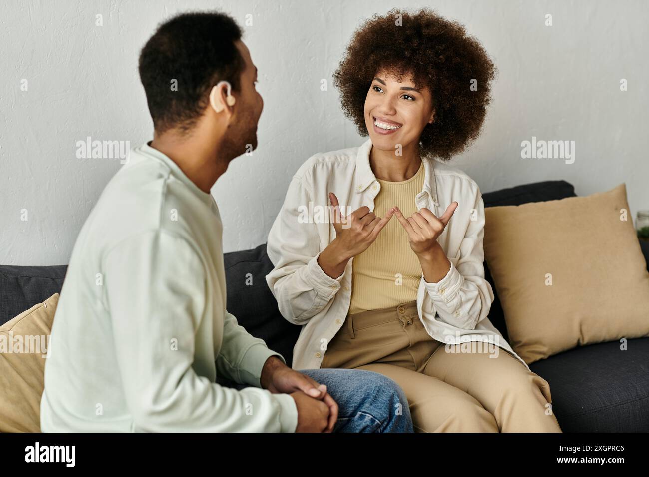 An African American couple communicates using sign language while ...