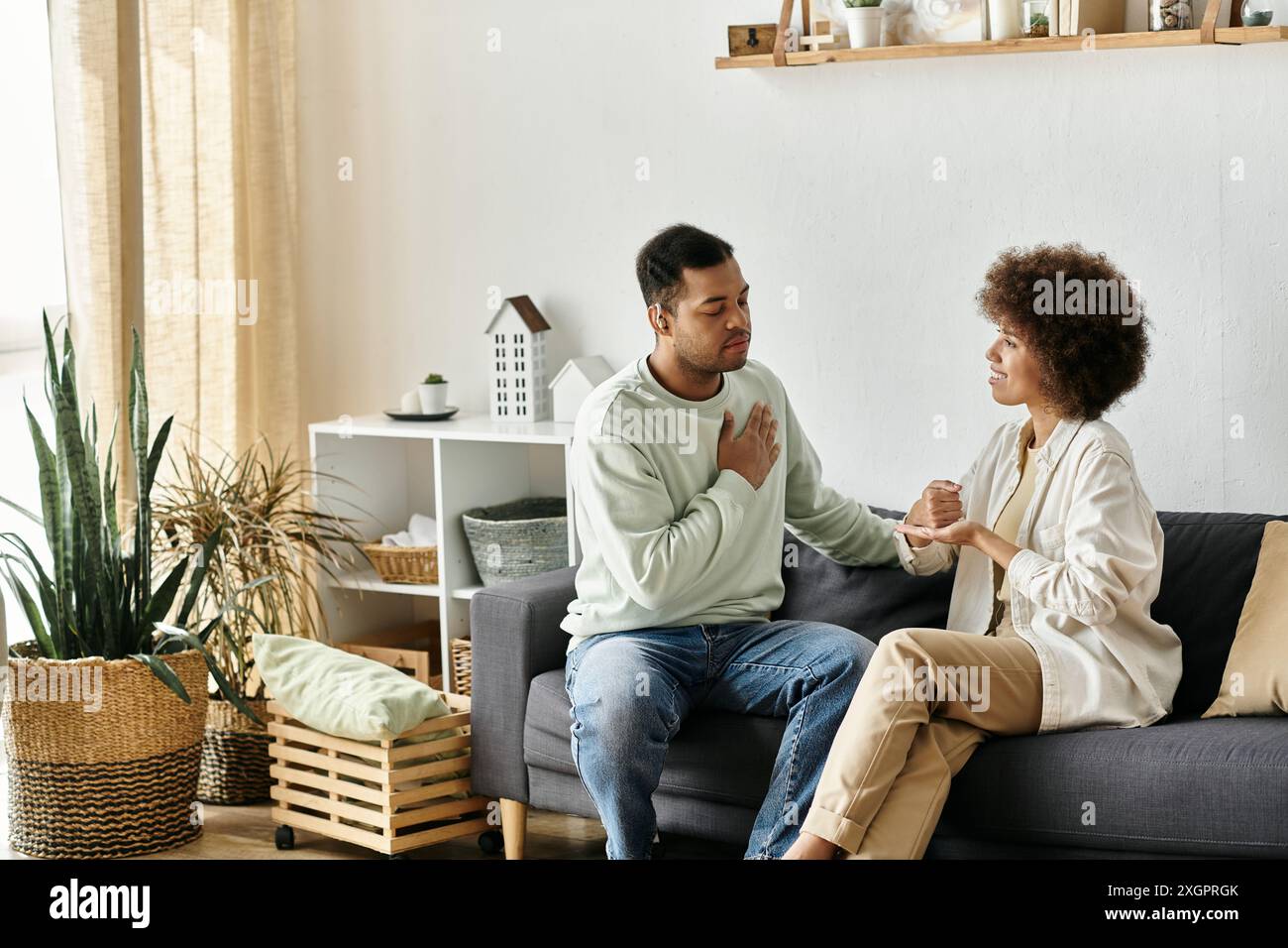 A loving African American couple uses sign language to communicate ...