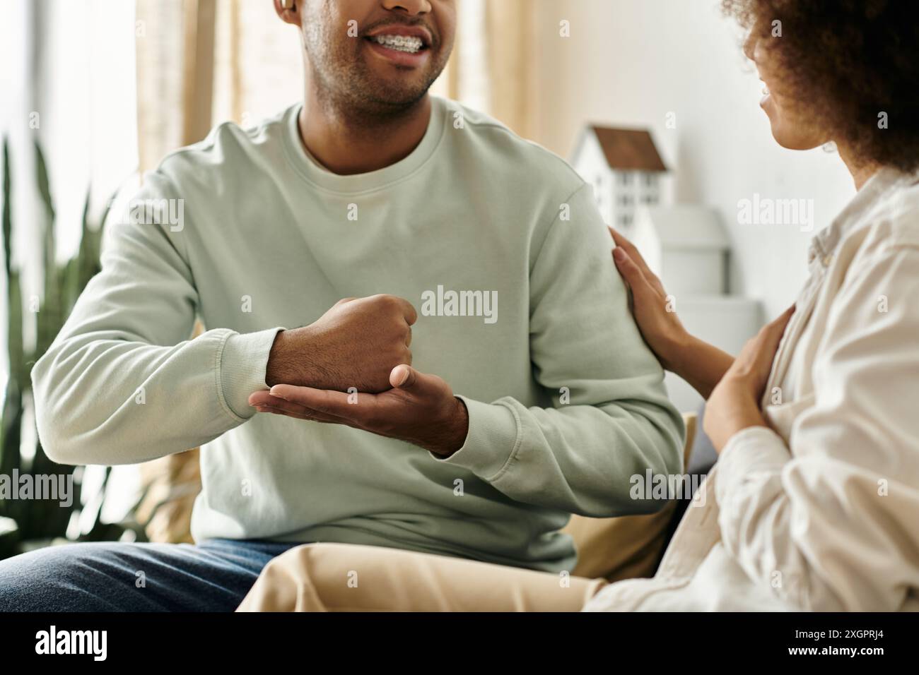 A couple in love, using sign language to communicate at home ...
