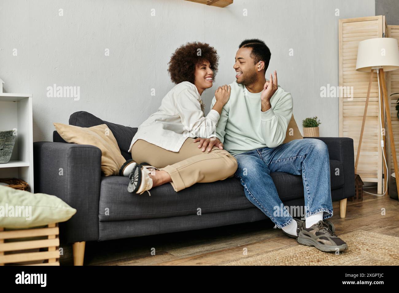 An African American couple uses sign language to communicate while ...