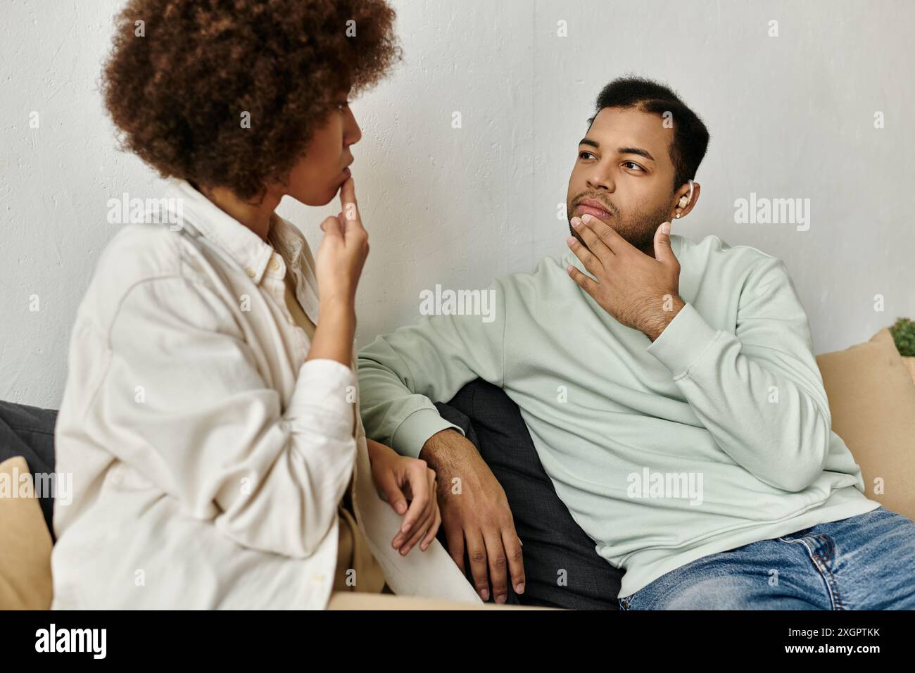 An African American couple uses sign language to communicate while ...