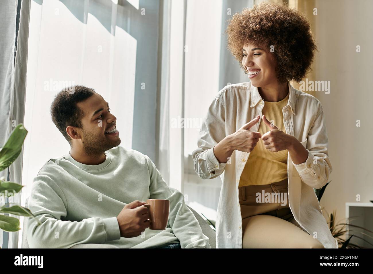 An African American couple uses sign language to communicate with each ...