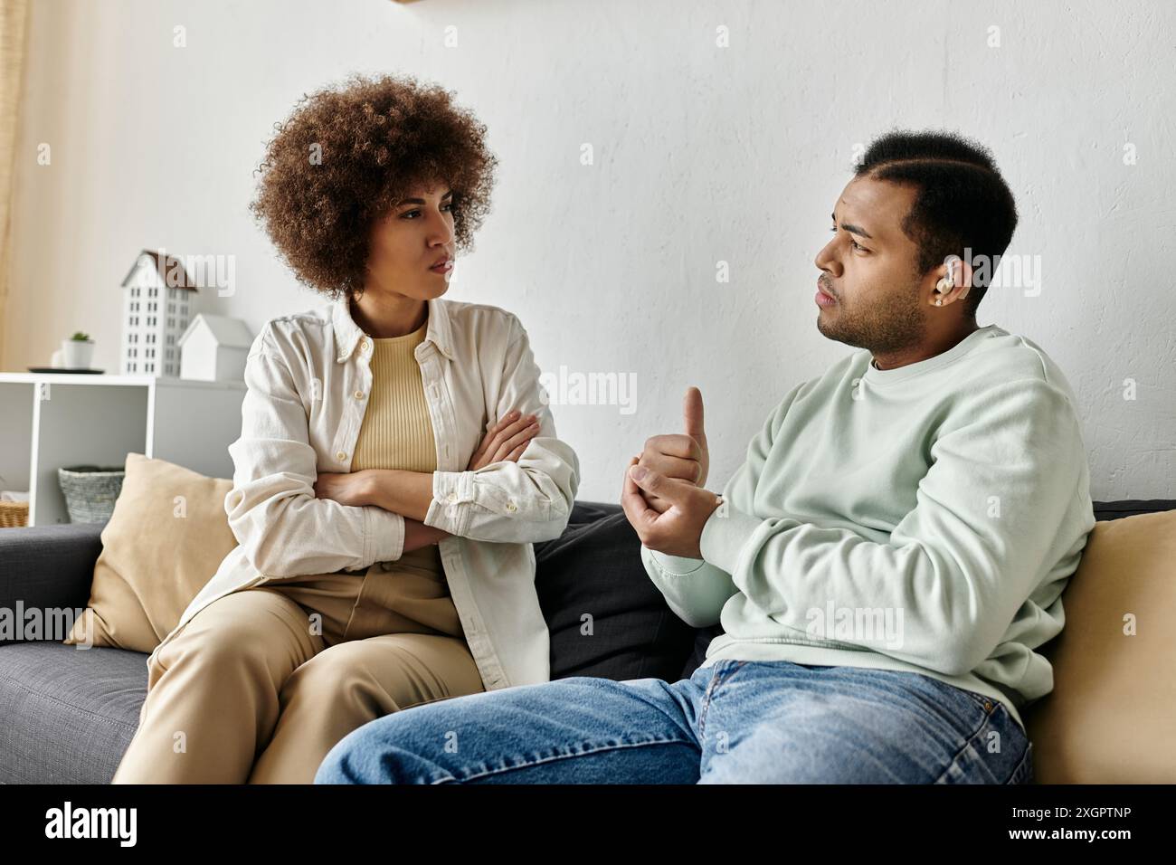 An African American couple uses sign language to communicate while ...