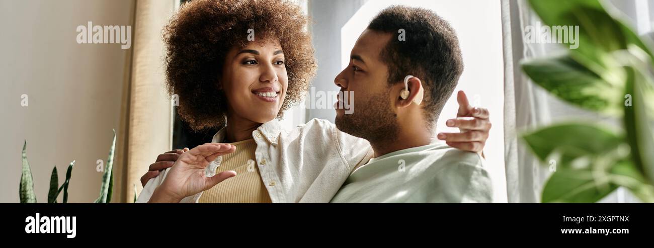 An African American couple uses sign language to communicate in their ...