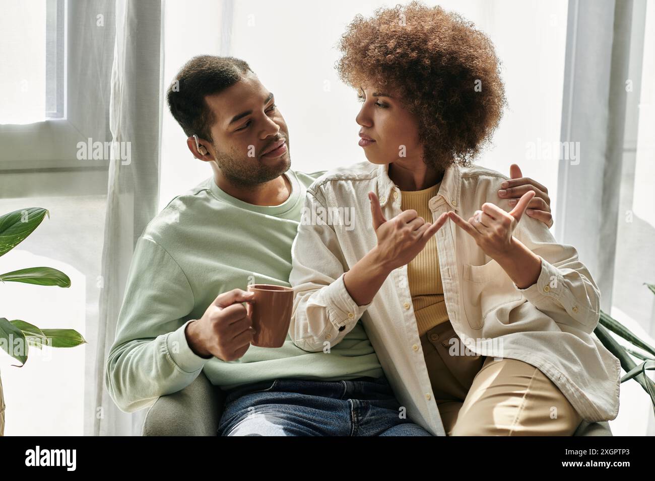 An African American couple uses sign language to communicate while ...