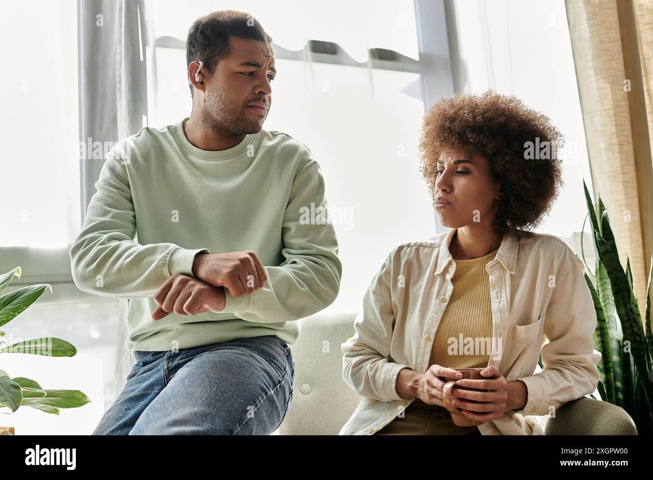 An African American couple communicates with sign language while ...