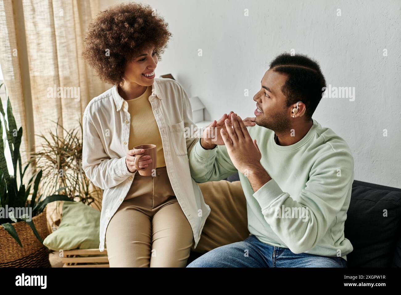 An African American couple communicates through sign language while ...