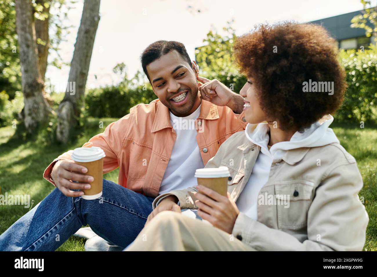 A happy African American couple enjoys a sunny day outdoors, using sign ...