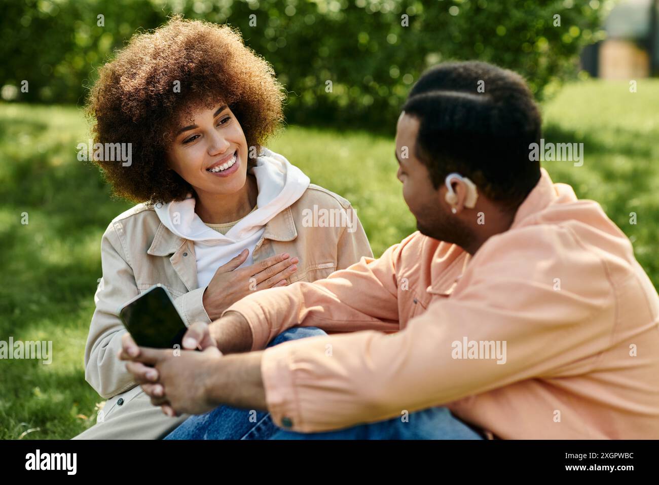 A happy African American couple communicates in sign language while ...