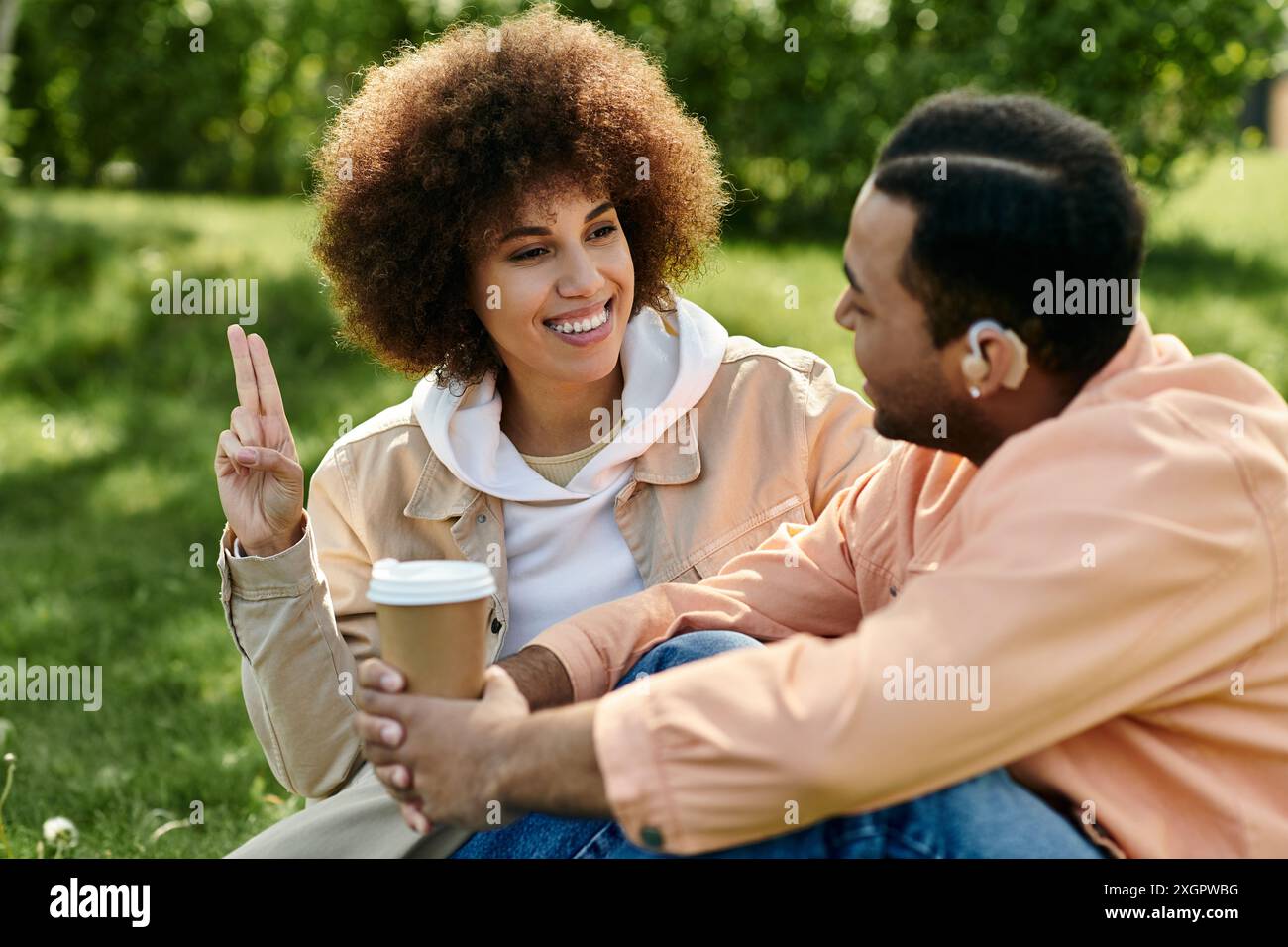 An African American couple communicates through sign language while ...