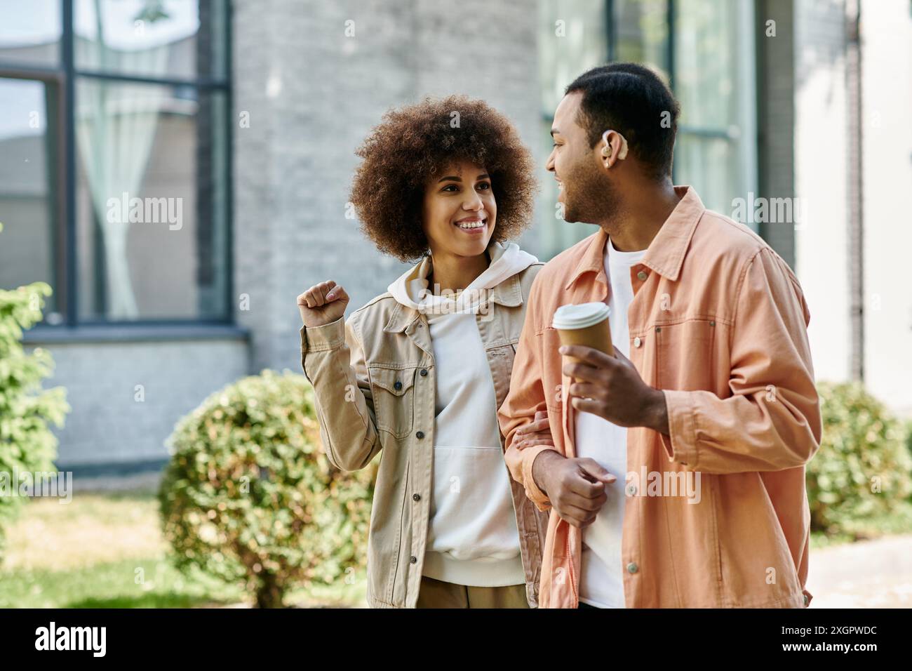 An African American couple walking and using sign language to ...