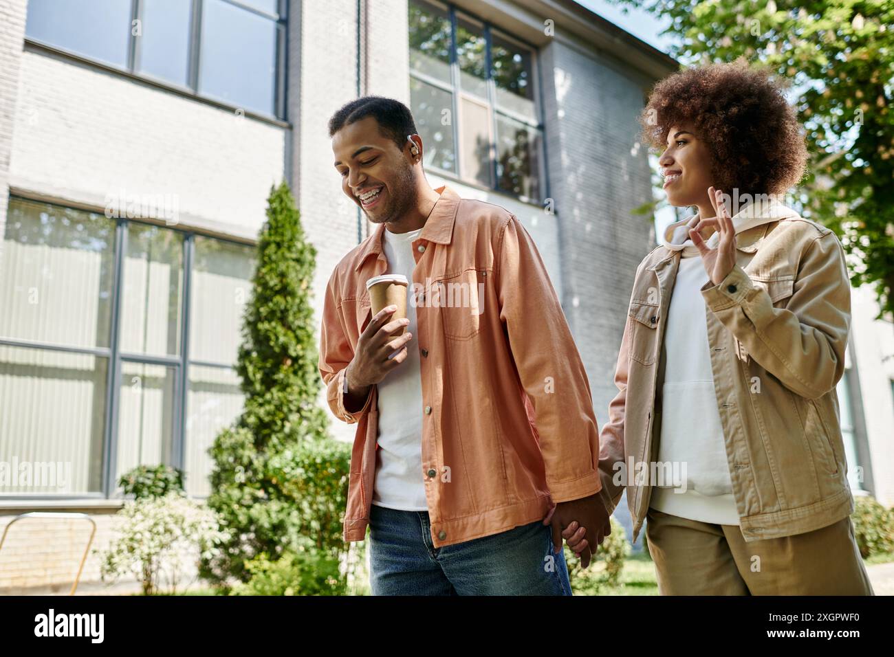 A happy African American couple walks hand-in-hand, communicating ...