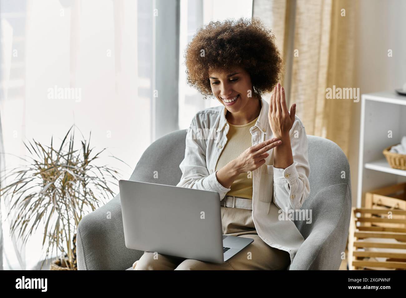 An African American woman communicates with sign language while sitting ...