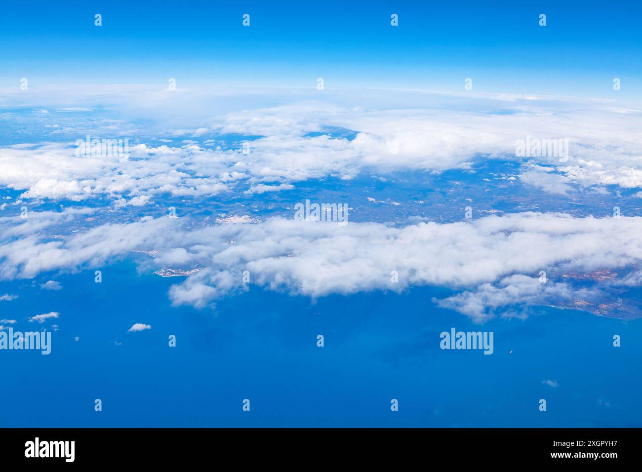 Aerial view of ocean and clouds from airplane window. Earth continent ...