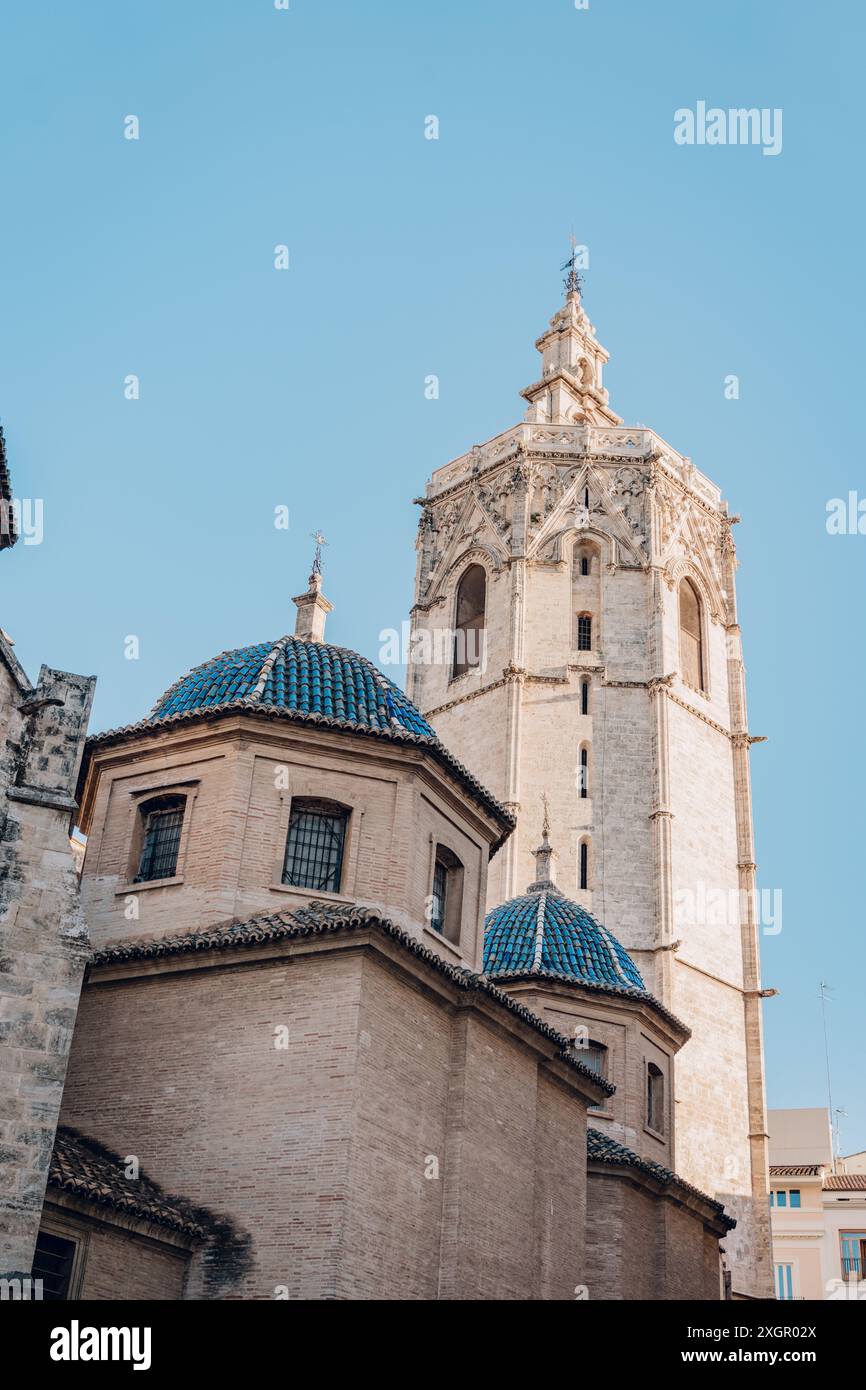 View of a historic bell tower with blue-tiled domes in Valencia. The ...