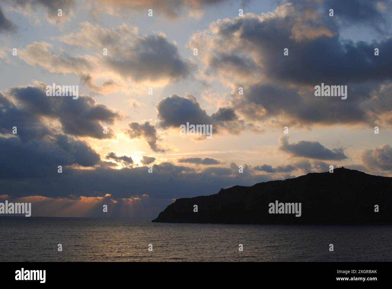 God rays. A summer sunset in Monemvasia, Greece Stock Photo - Alamy