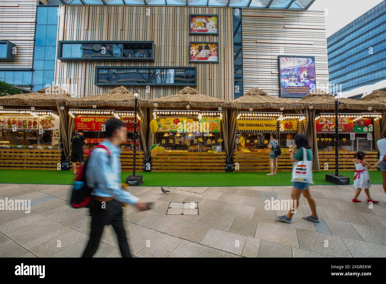 People walking pass outdoor street food market. Singapore Stock Photo ...