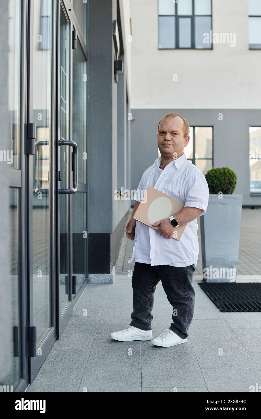 A man with inclusivity with a disability stands confidently outside a ...