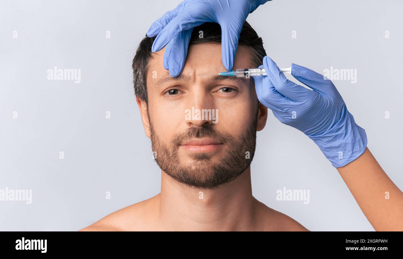 Man Receiving Forehead Injection Stock Photo - Alamy