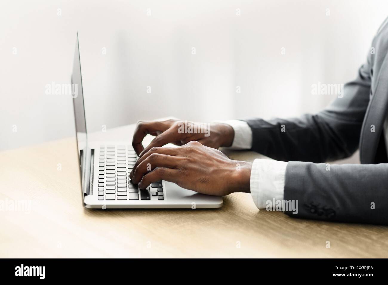 Businessman typing on laptop at office desk hi-res stock photography ...
