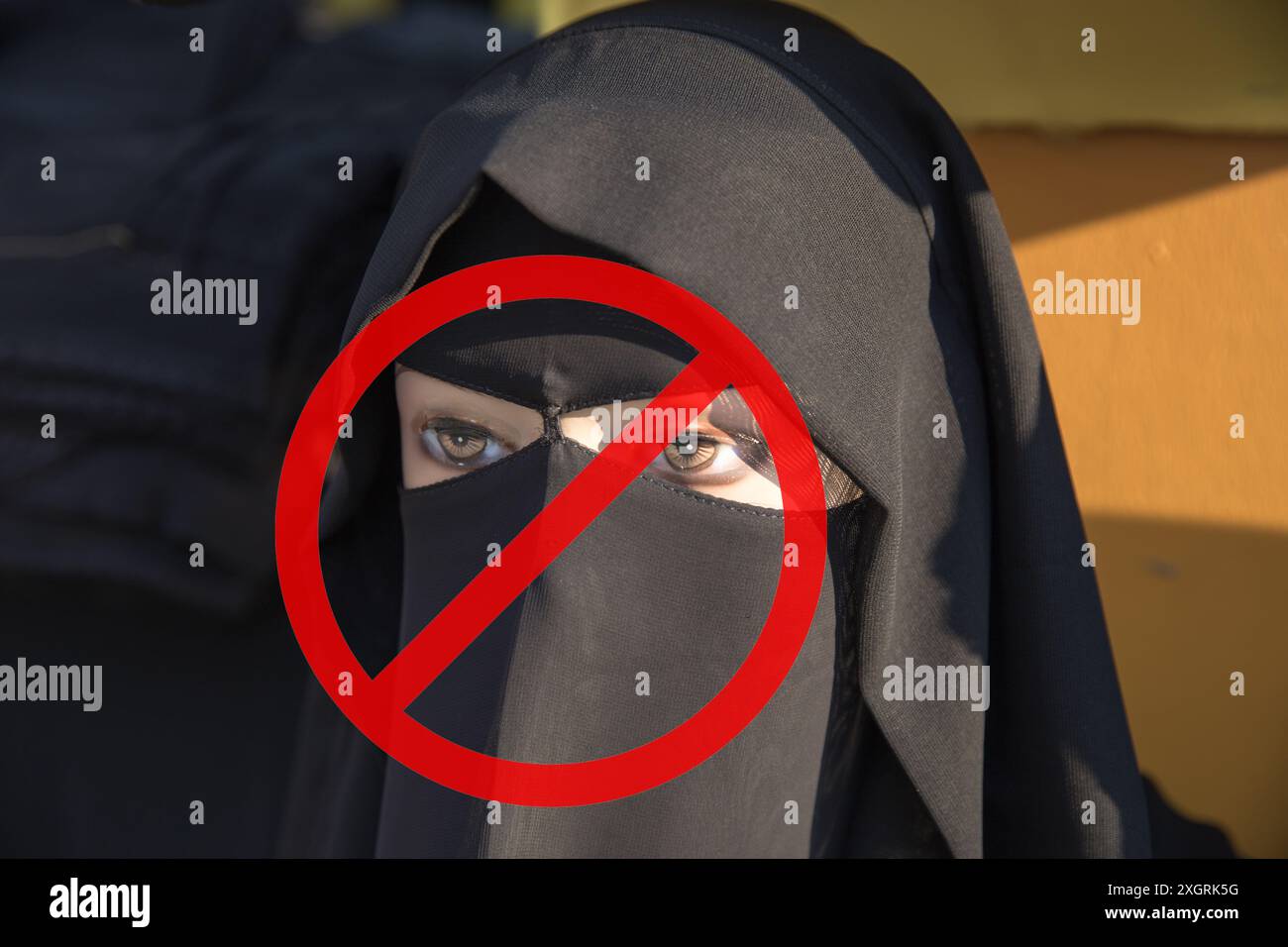 Mannequin wearing muslim traditional black clothing with stop sign ...