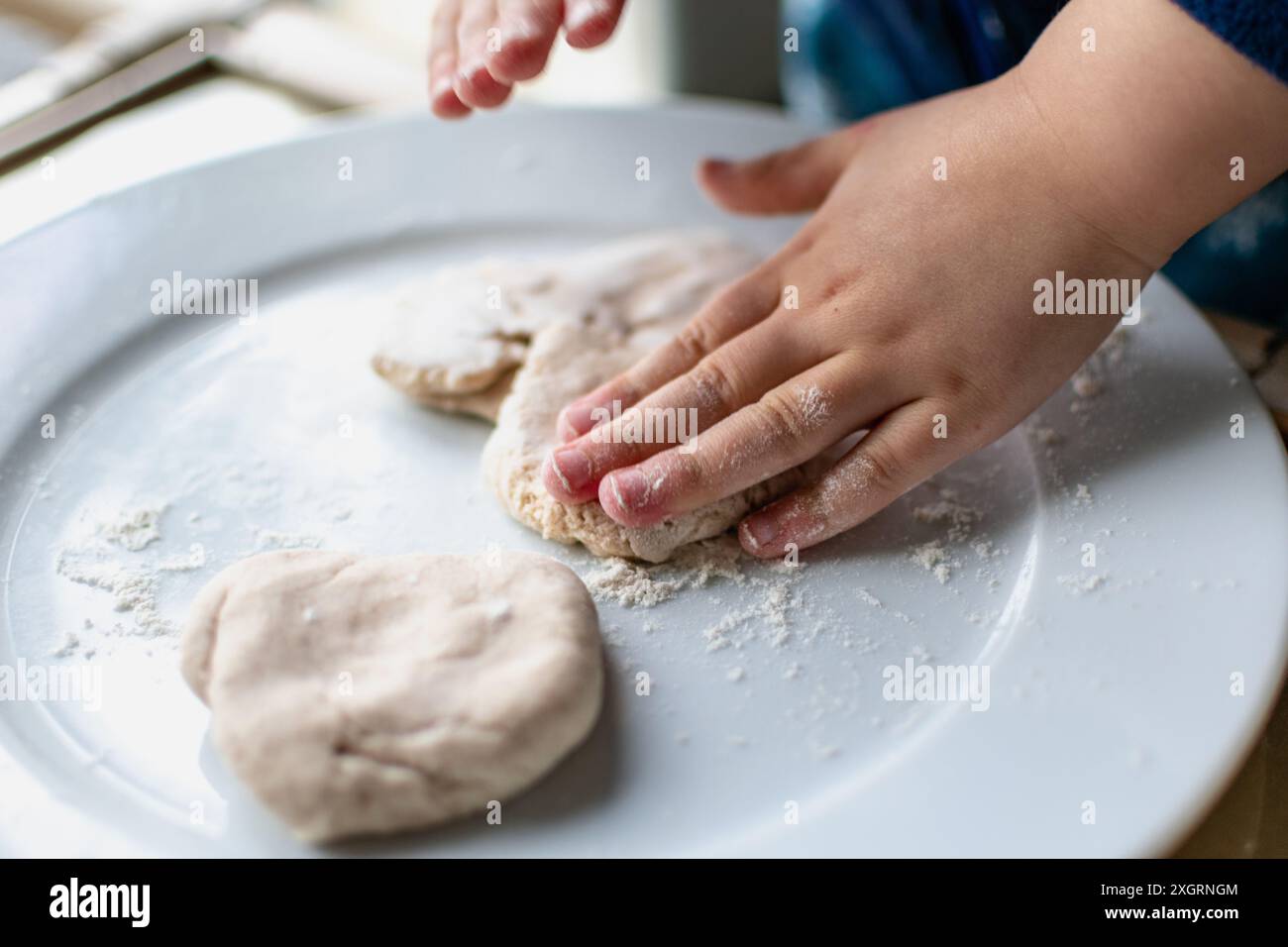 Child having fun modeling salt dough, authentic activity, fine motor ...