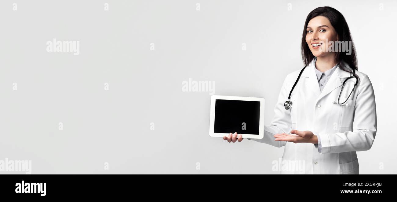 Positive Doctor Using Tablet Giving A Presentation On White Background ...