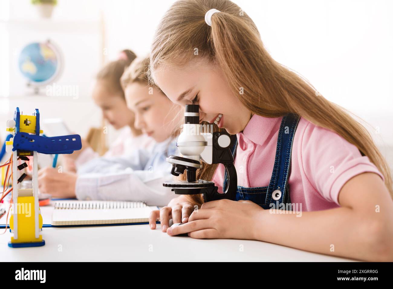 Young Girl Using Microscope During Elementary Science Class Stock Photo ...
