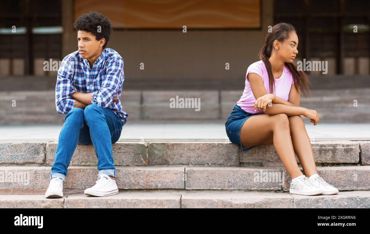Teen Couple Sitting Apart on Concrete Steps Outdoors Stock Photo - Alamy