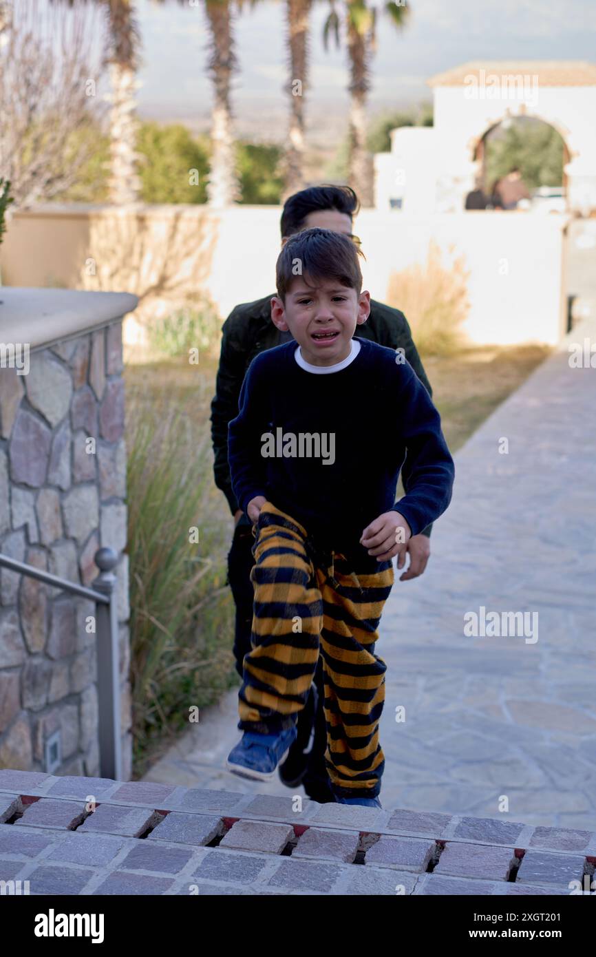 Child climbing latino hi-res stock photography and images - Alamy