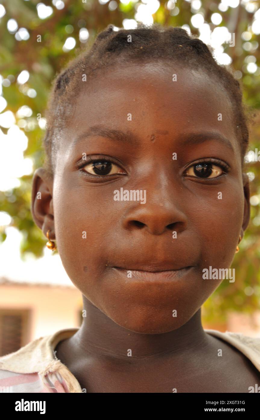 Young girl with pretty ear-rings, biting her lip, Ligogo, Inhambane, Mozambique Stock Photo - Alamy