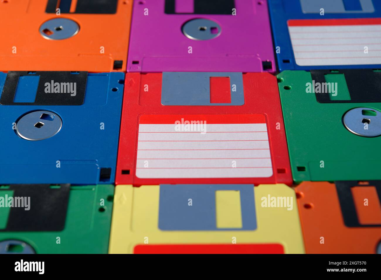Vintage colored floppy disks background. Old technologies. Selective ...