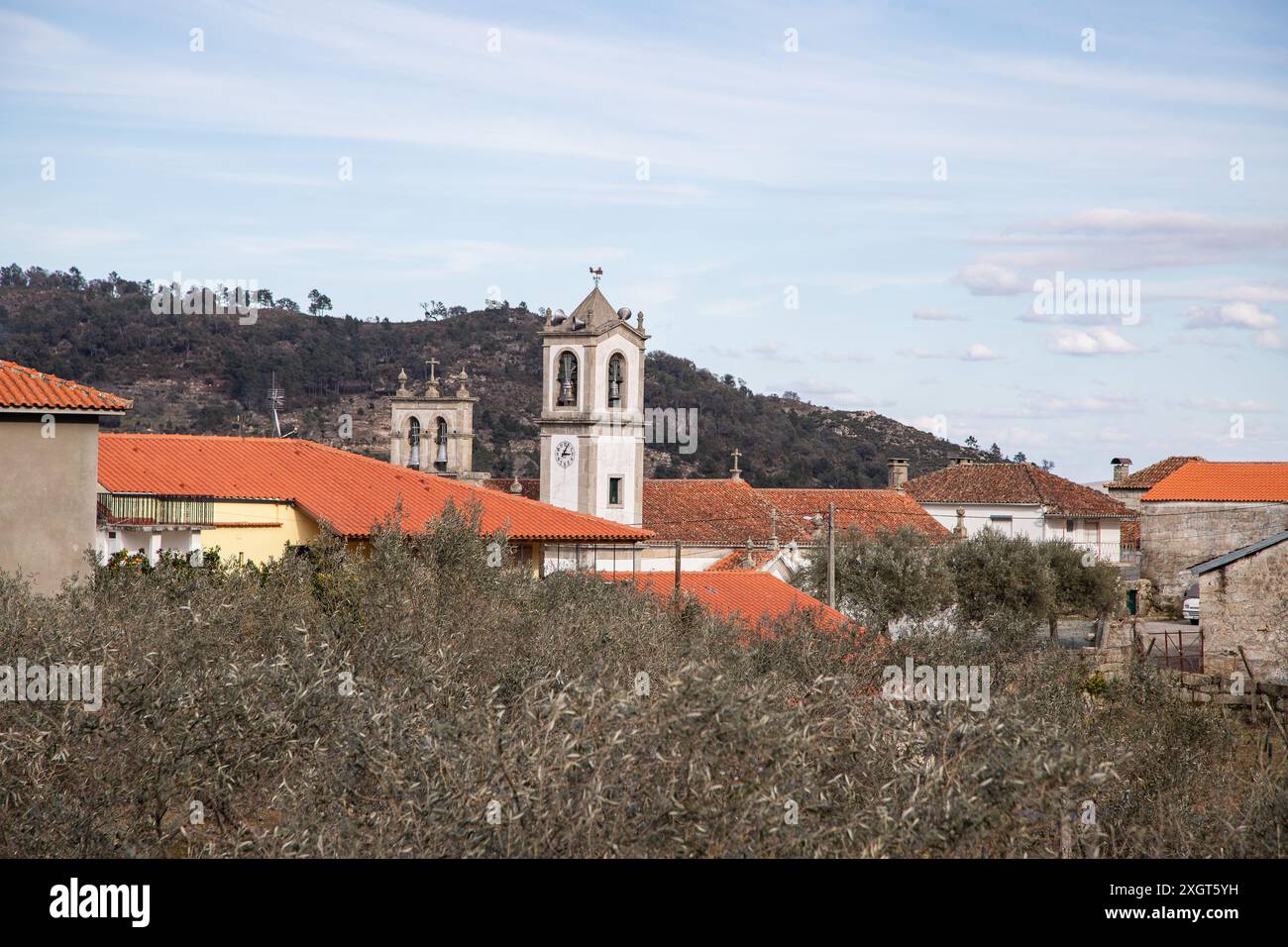 Picturesque view of a small village with red roofs and a church tower ...